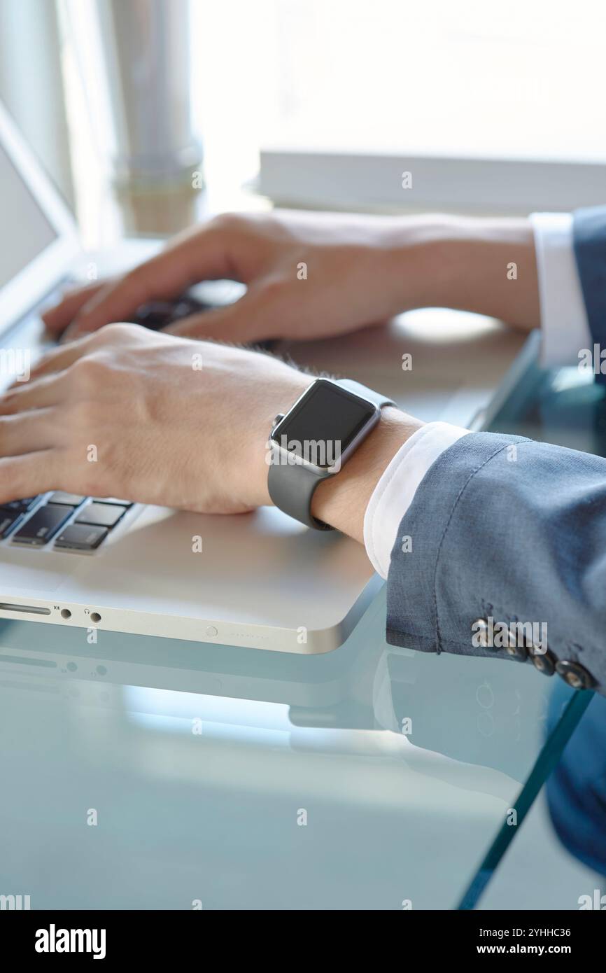 Man working wearing a smartwatch Stock Photo - Alamy
