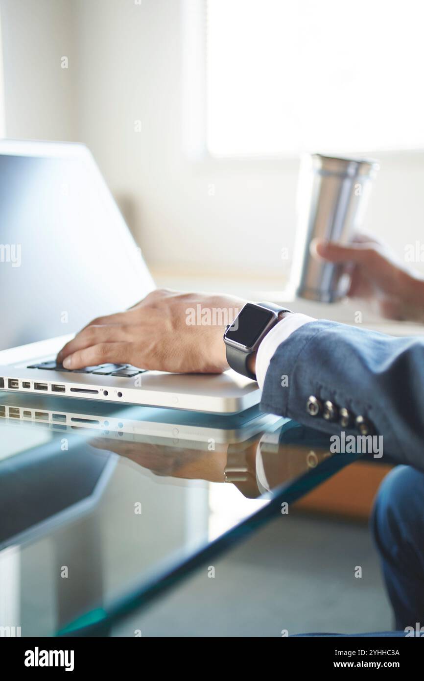 Man working wearing a smartwatch Stock Photo - Alamy