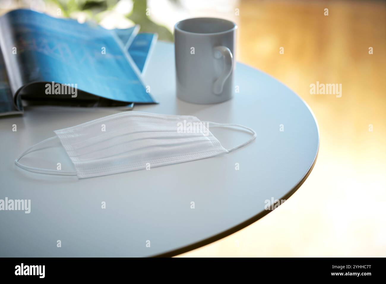 Mask, guidebook and mug Stock Photo - Alamy