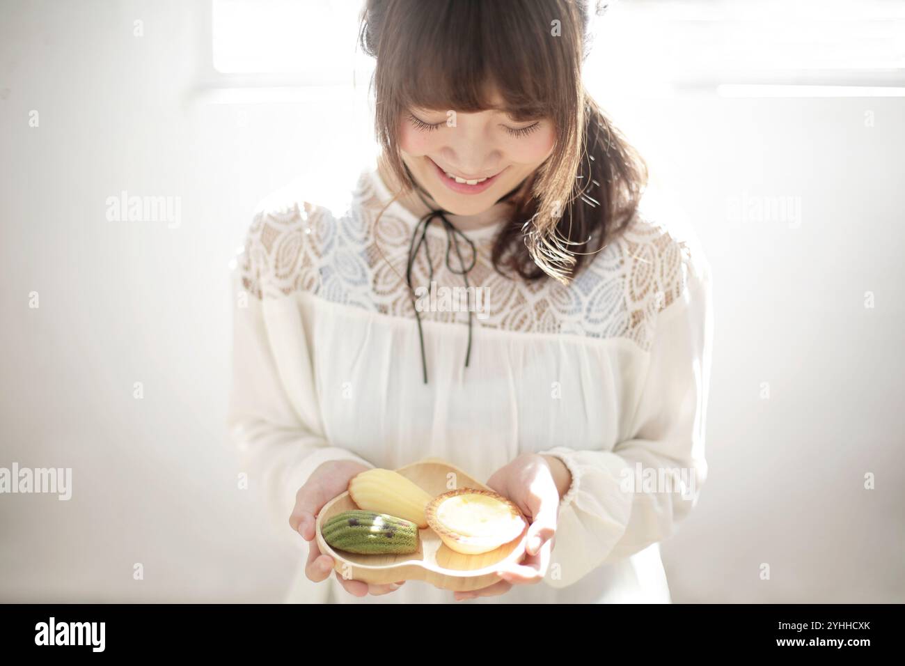 Smiling university students holding cake in their hands Stock Photo - Alamy