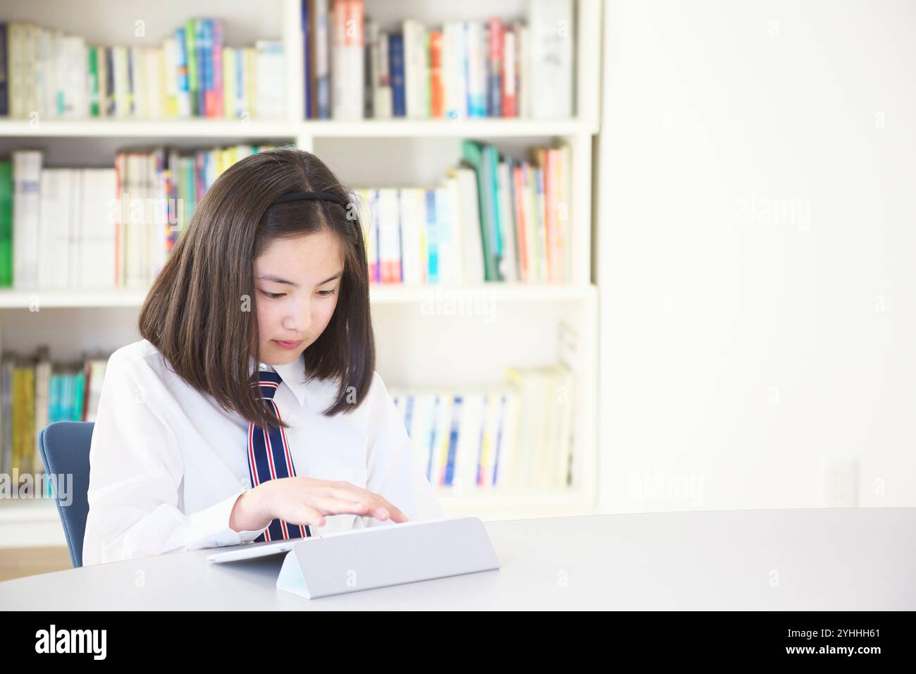 Junior high school girl operating a tablet Stock Photo - Alamy
