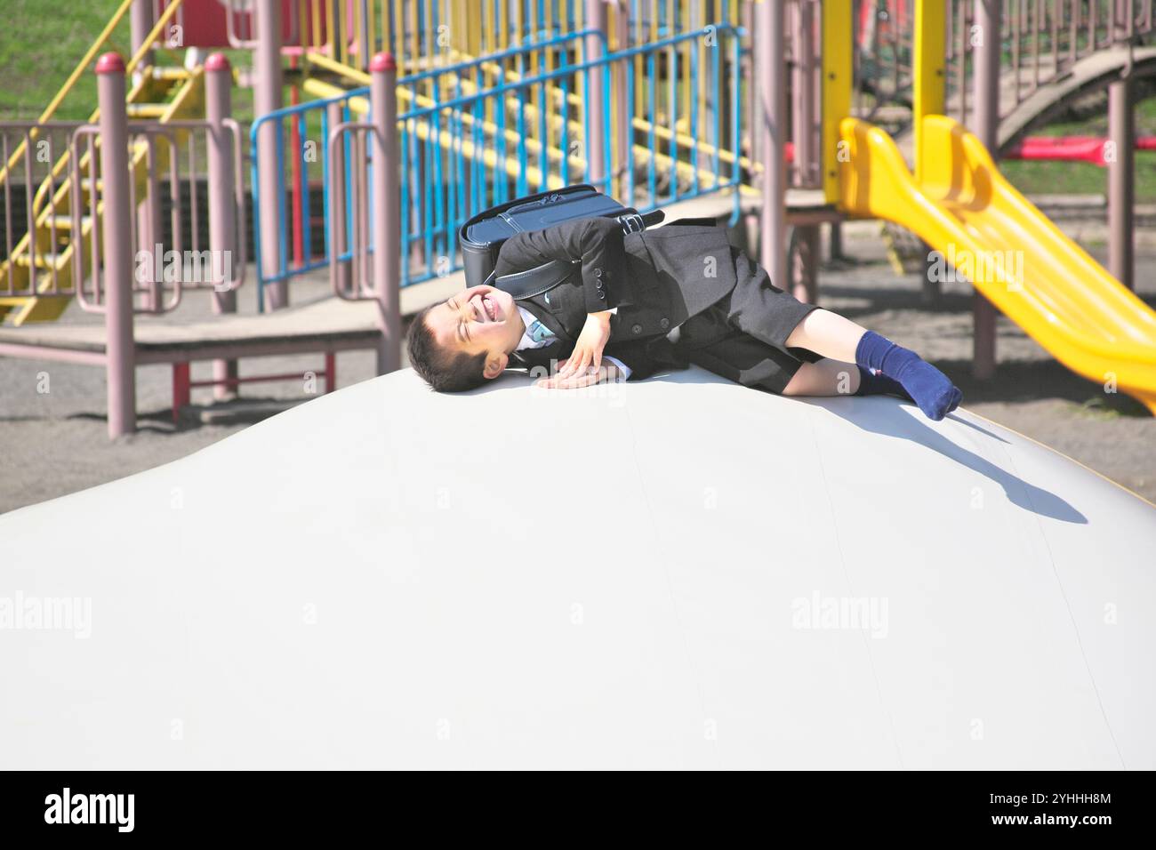 First grade boy laughing on park playground equipment Stock Photo - Alamy
