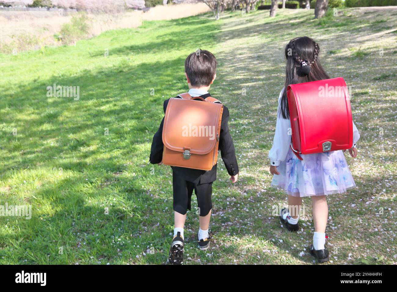 First grade primary school girls and boys carrying school backpacks ...