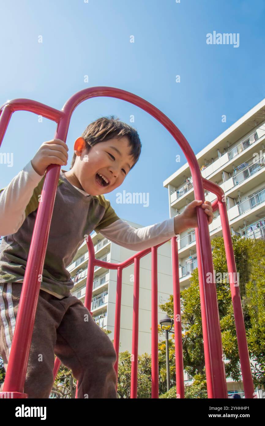 Boy playing on the slide Stock Photo - Alamy