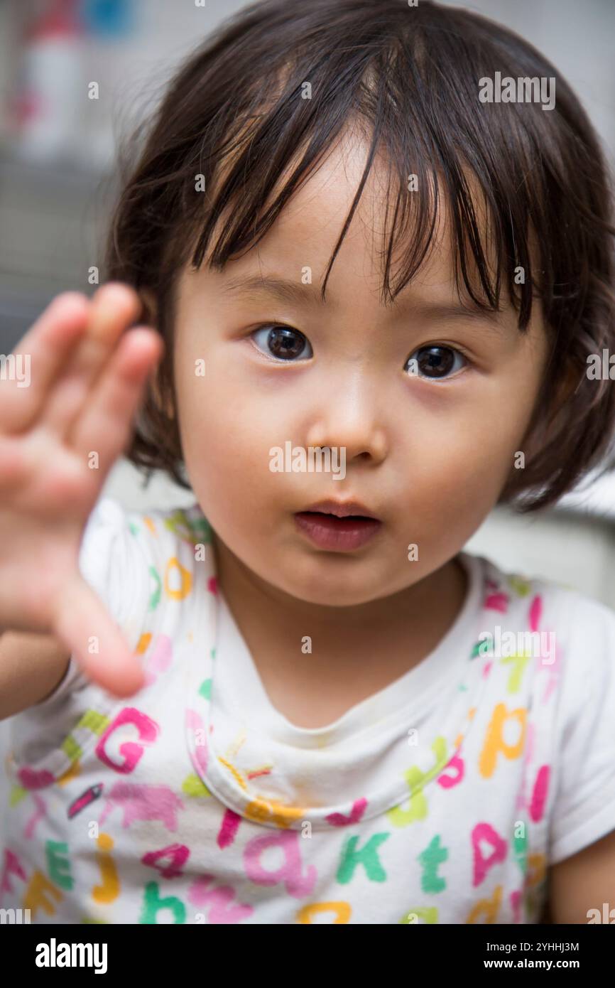 Girl holding her hands out in front of her Stock Photo - Alamy