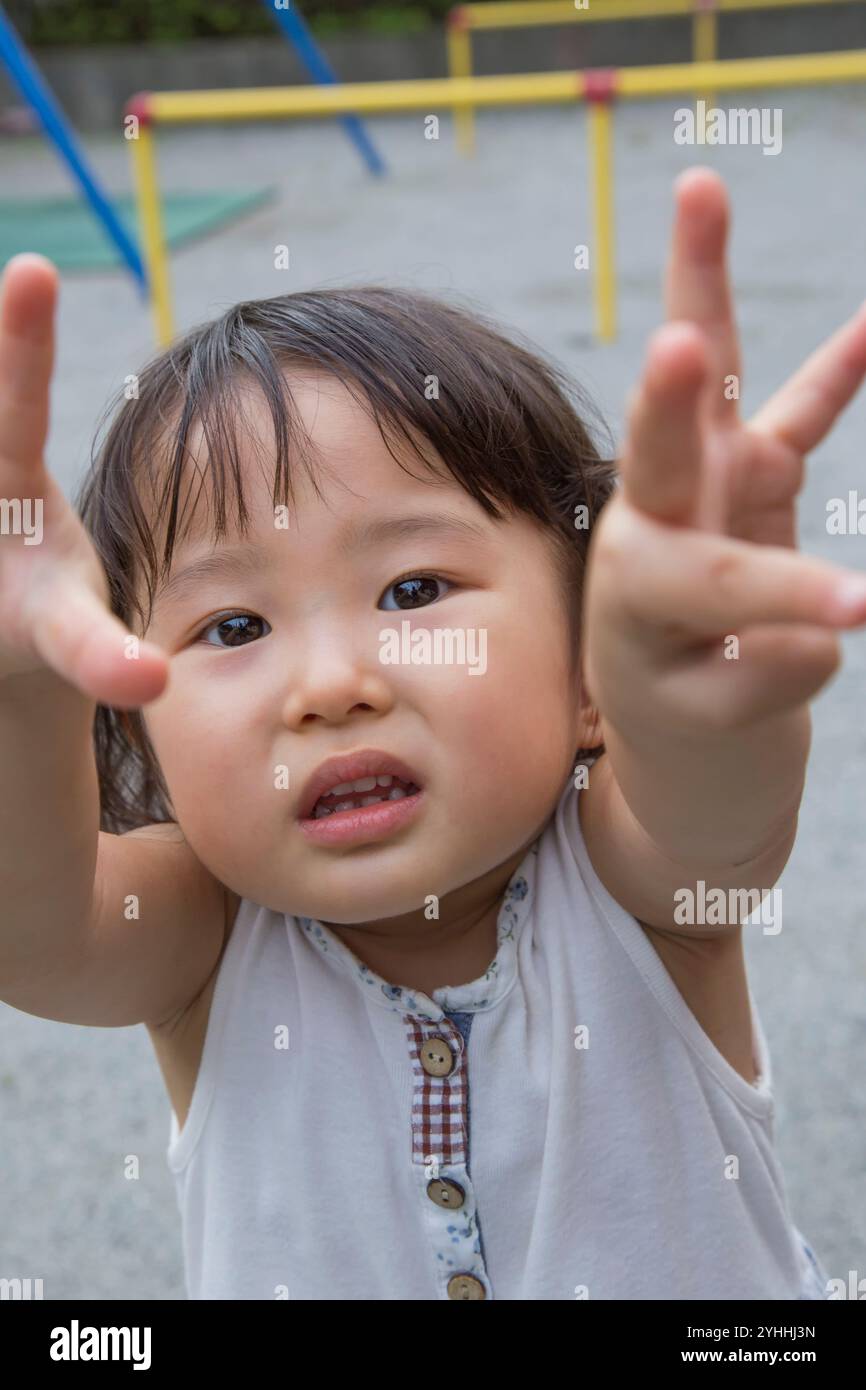Girl holding out both hands Stock Photo - Alamy