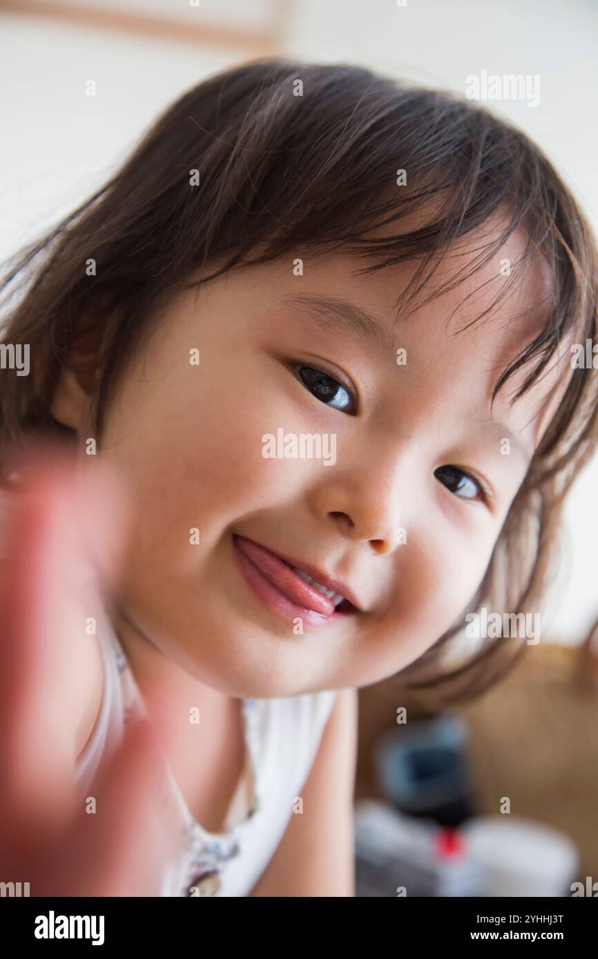 Girl holding out her bottom and holding out her hand Stock Photo - Alamy