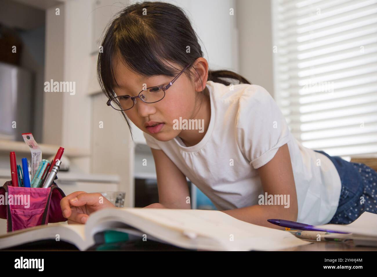 Girl lying down and studying Stock Photo - Alamy