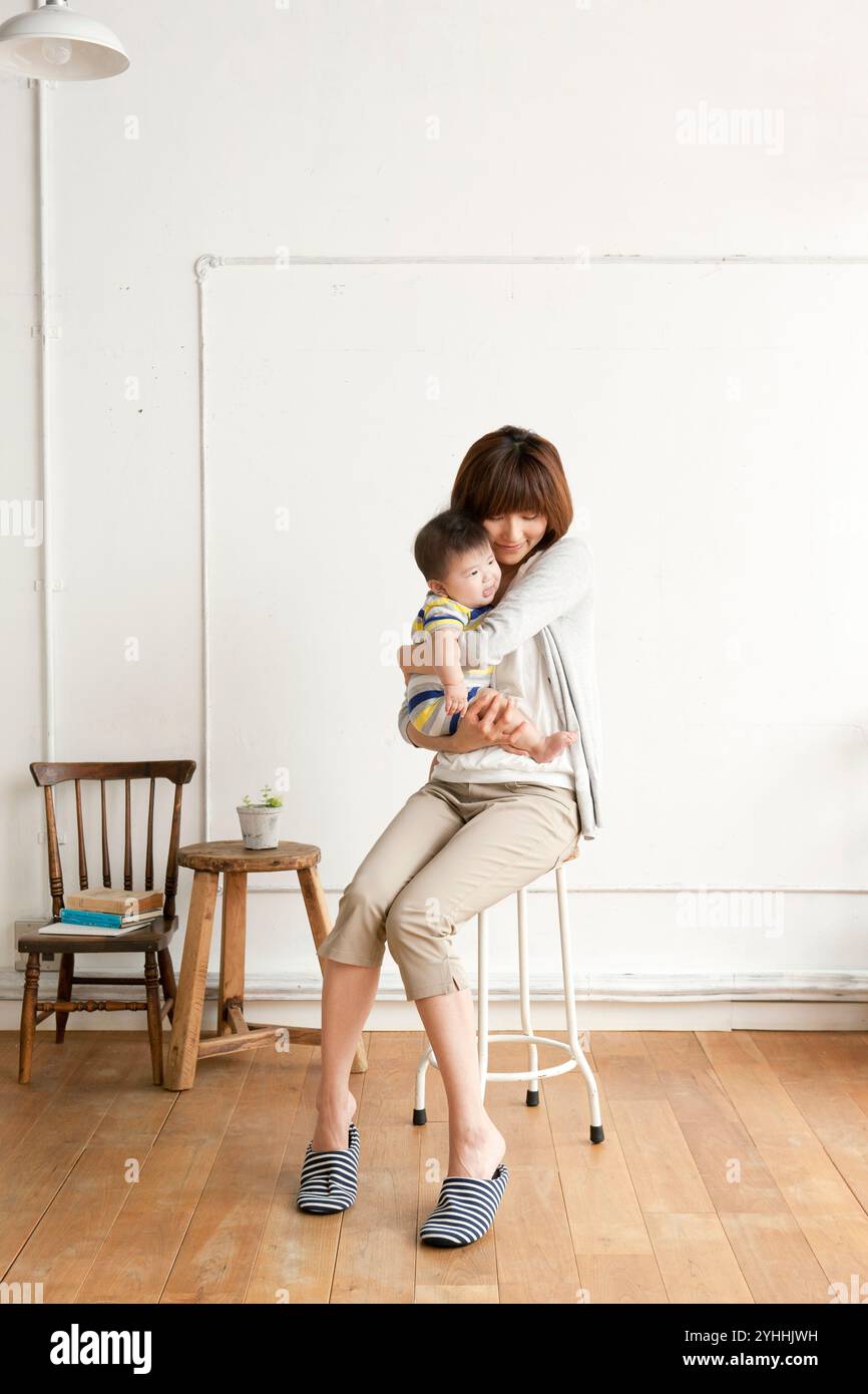 Mother holding infant Stock Photo - Alamy