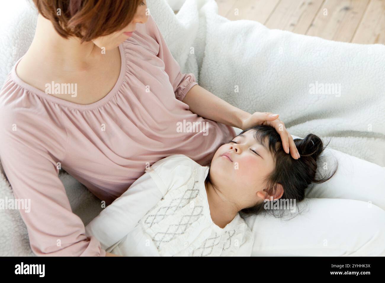 Child sleeping on knees Stock Photo - Alamy