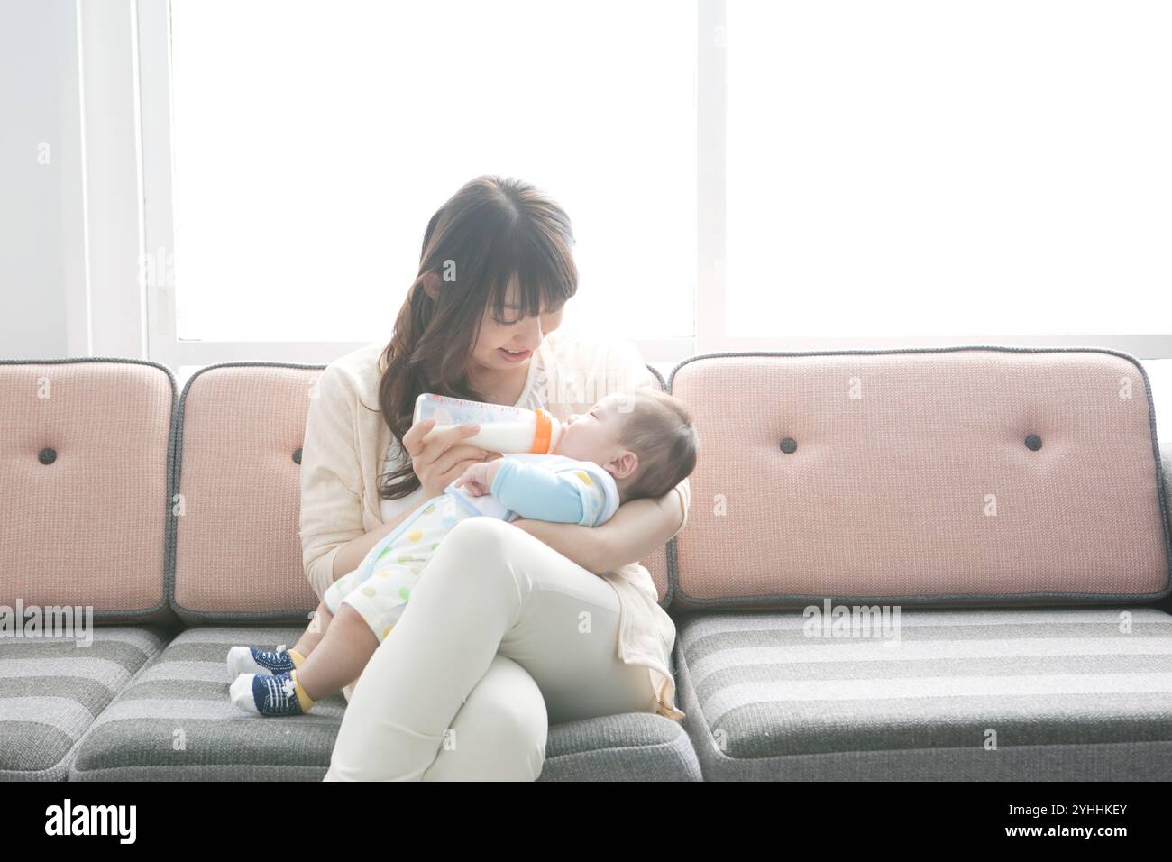 Woman giving child drink hi-res stock photography and images - Alamy