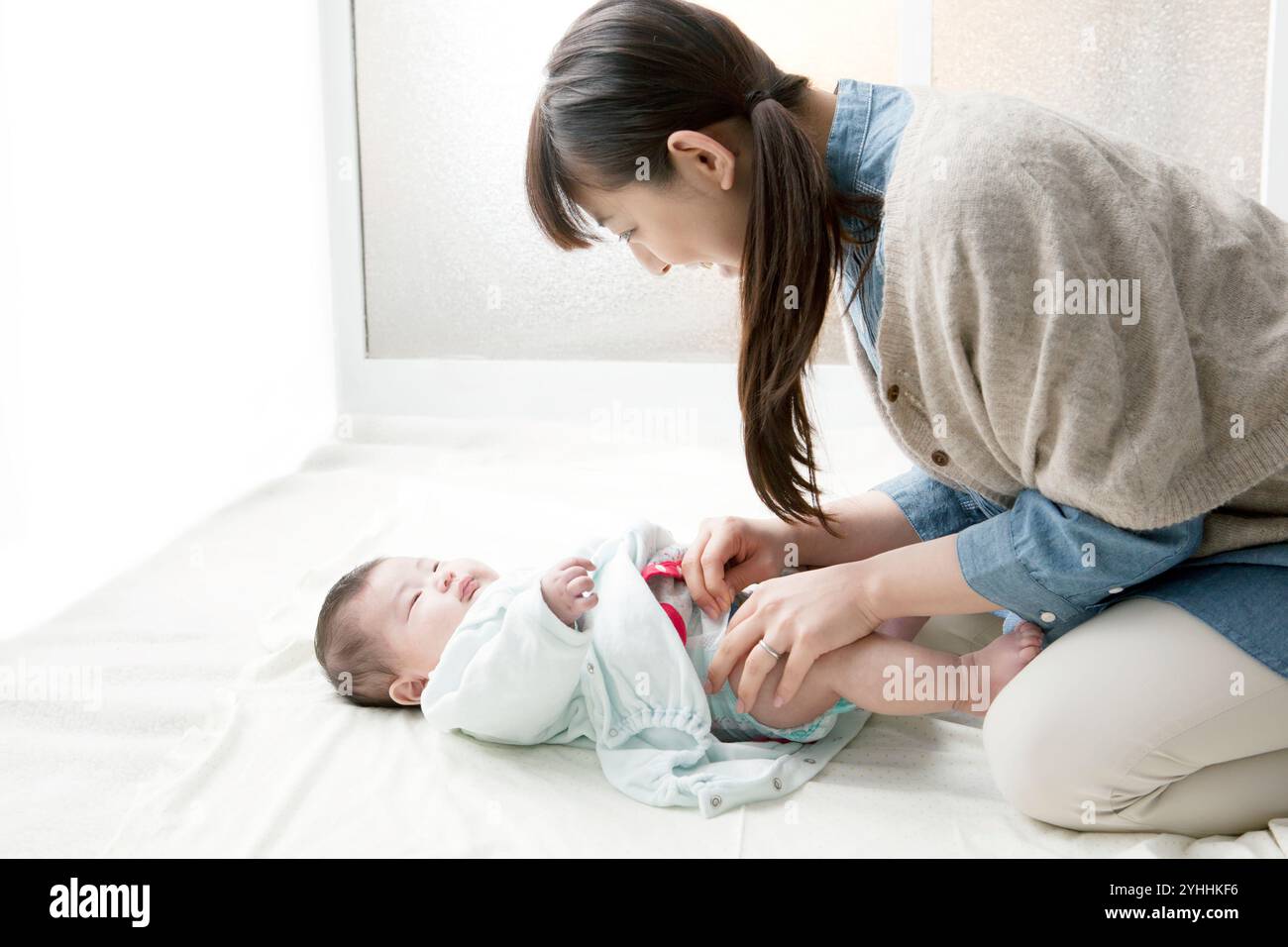 Mother and baby changing diaper Stock Photo - Alamy