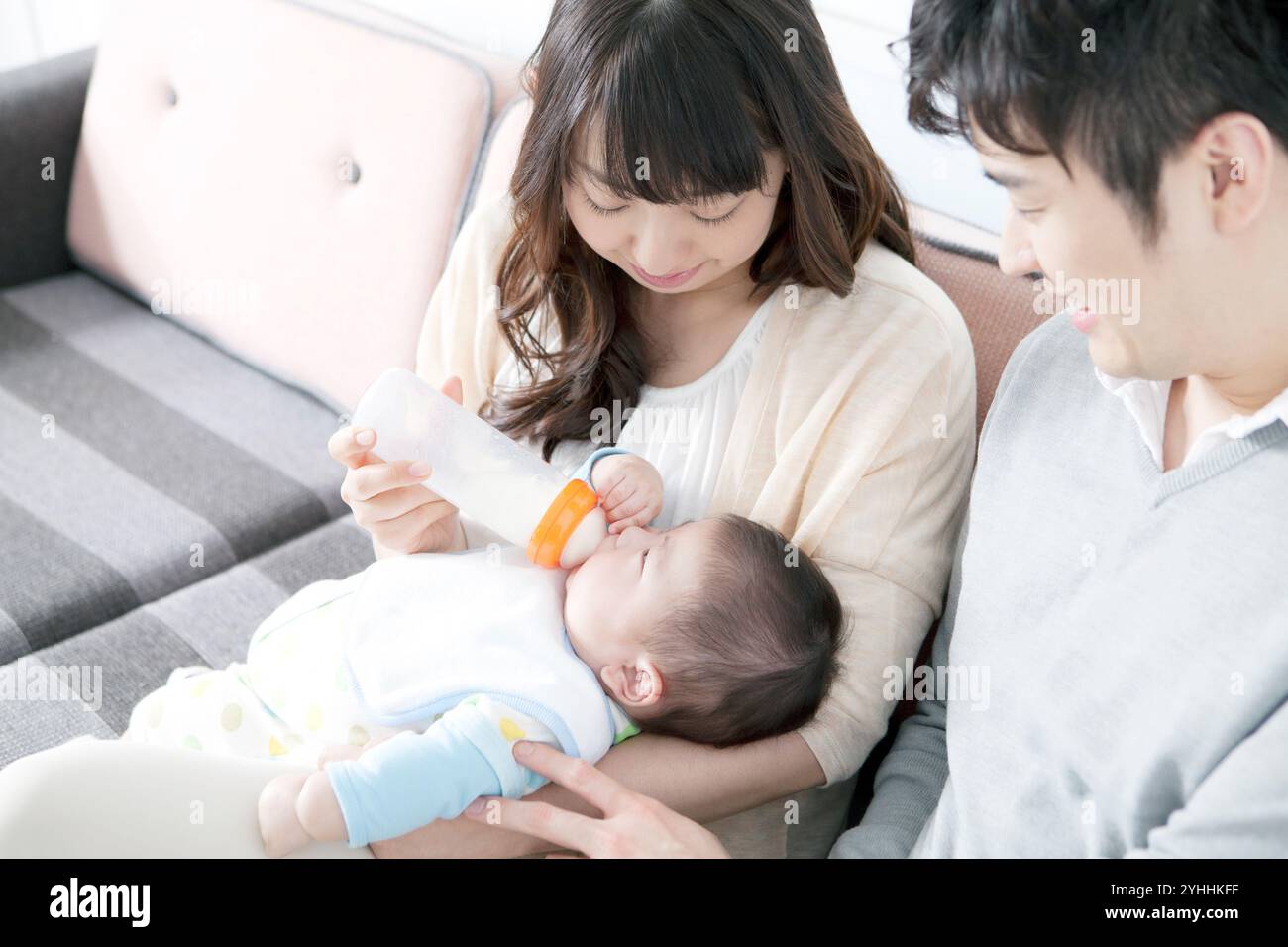 Mother giving milk to baby Stock Photo - Alamy