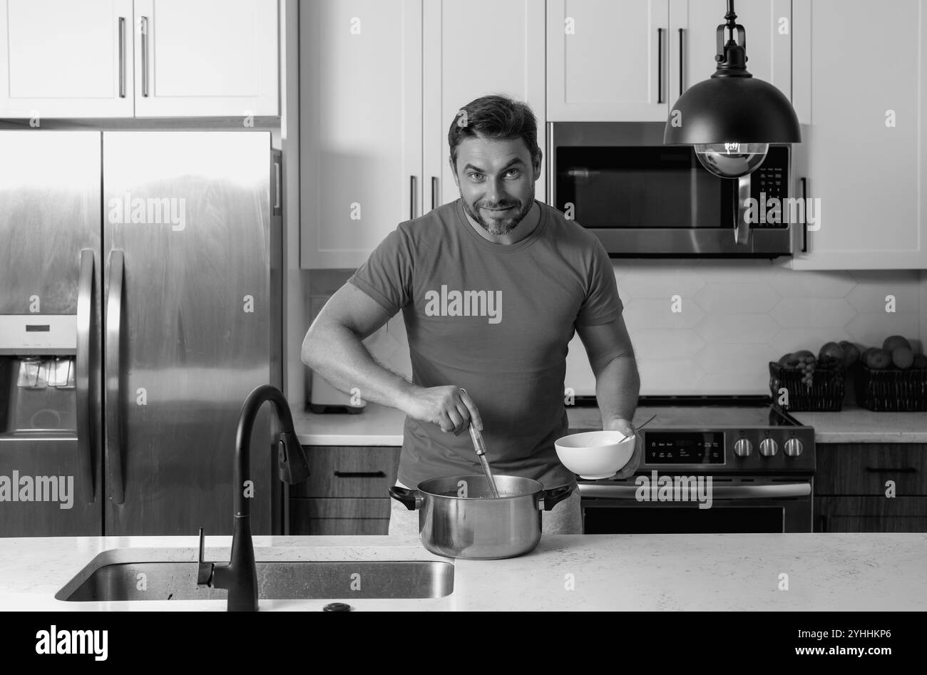 Man chef cooking food in pan pot in kitchen. Process of preparing ...