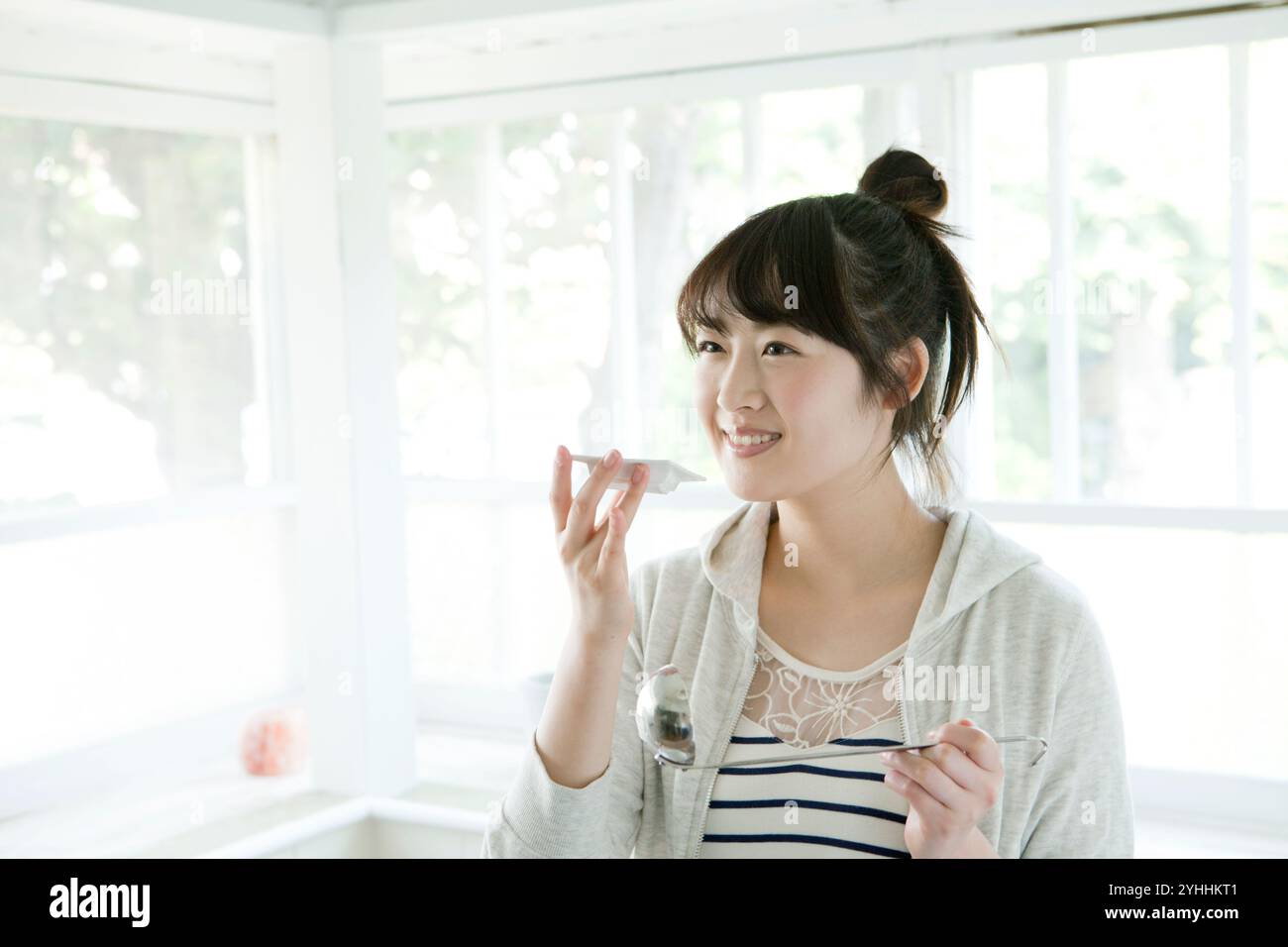 Teenage female college student tasting food Stock Photo - Alamy