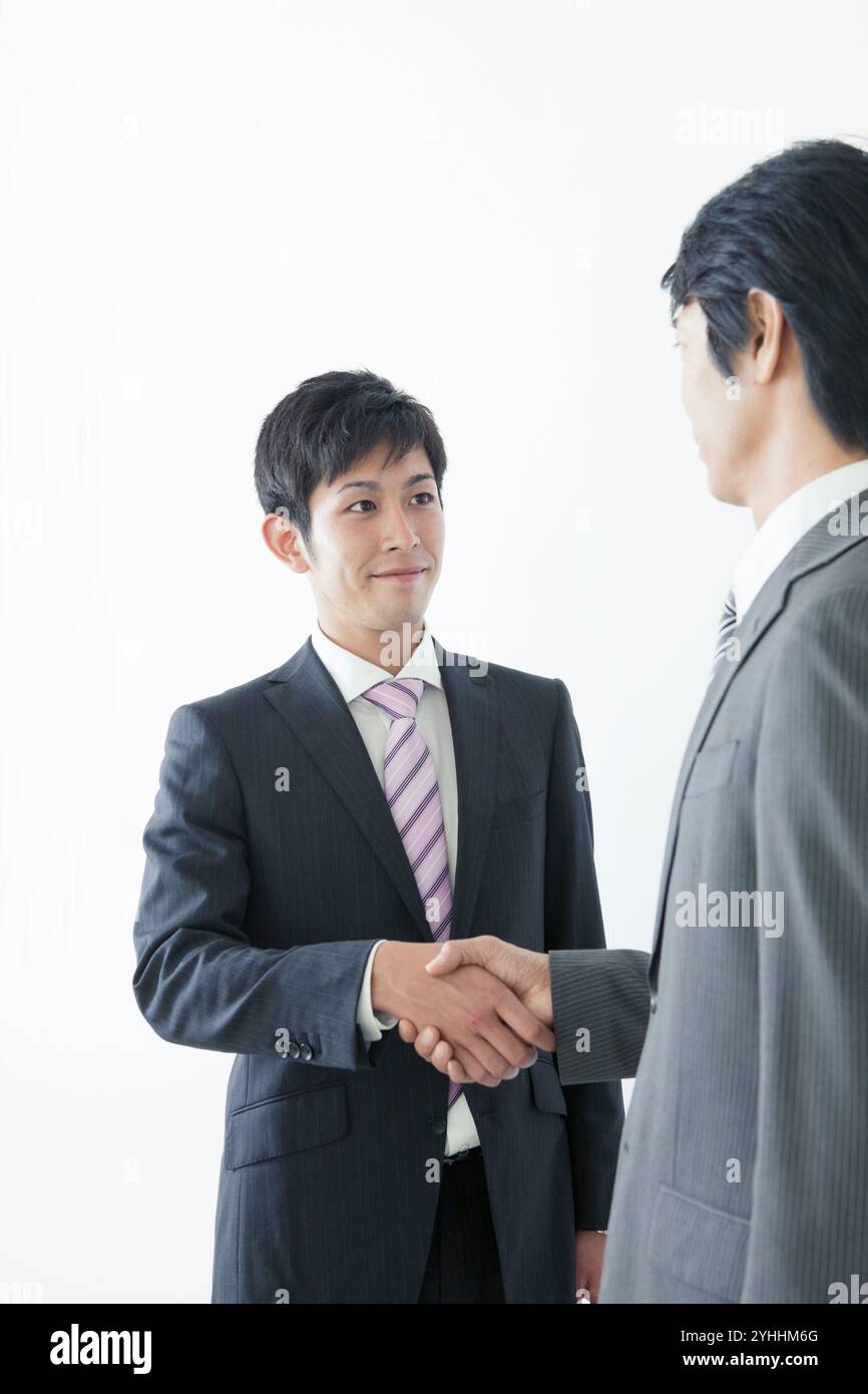 Boss and subordinate shaking hands Stock Photo - Alamy