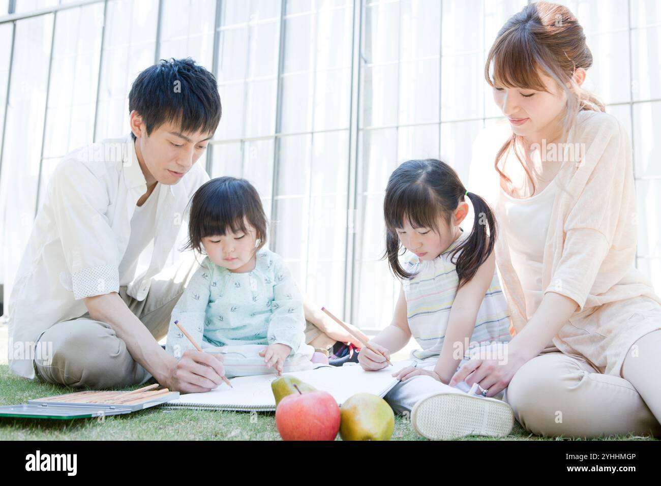 Two children and their parents drawing in the sketchbook Stock Photo ...