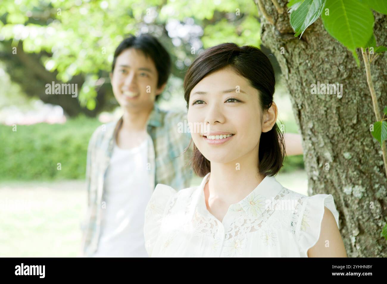 Woman under tree Stock Photo - Alamy