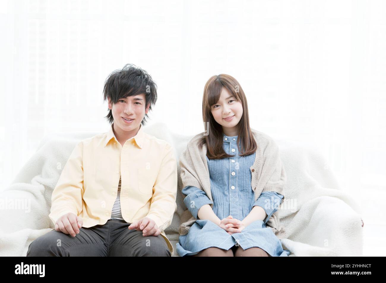 Couple sitting side by side on sofa hi-res stock photography and images ...