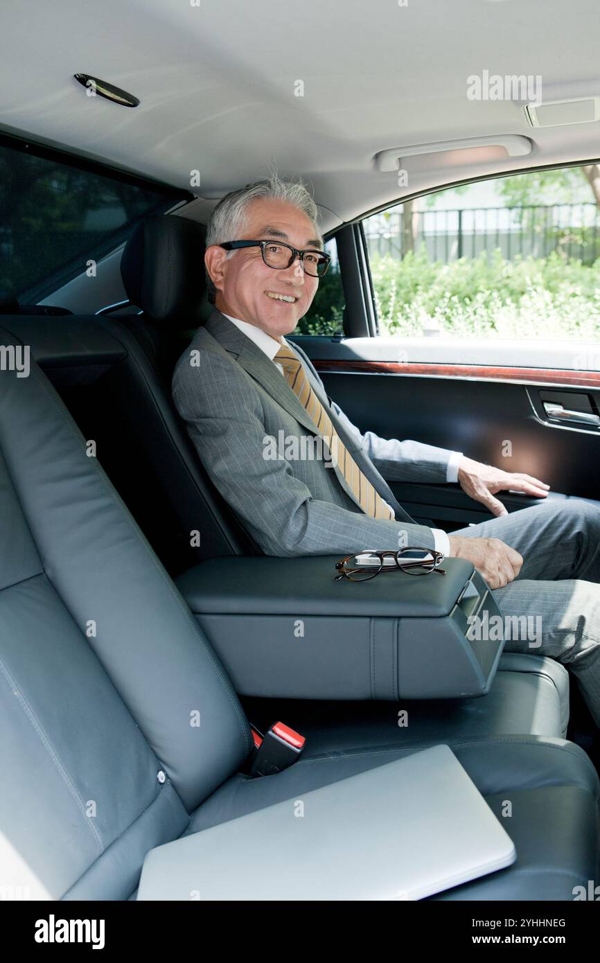Middle-aged businessman inside a car Stock Photo - Alamy