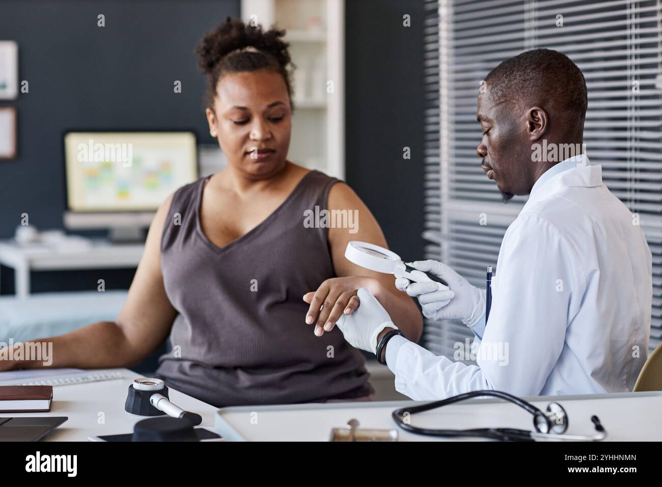 Side view portrait of African American doctor examining female patient ...