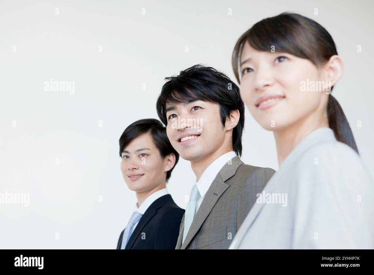 Three company employees photographed at an angle Stock Photo - Alamy