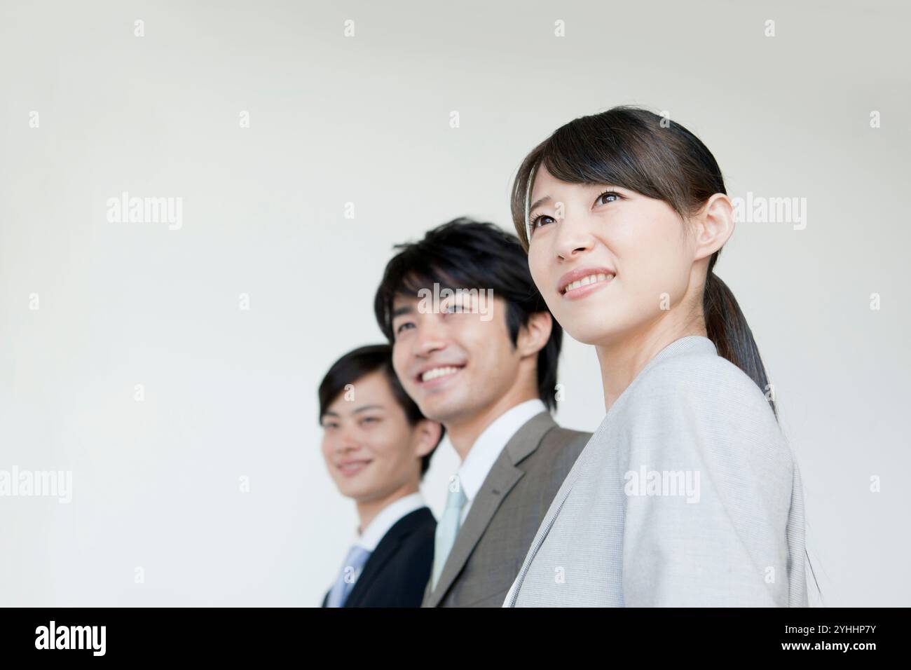 Three company employees photographed at an angle Stock Photo - Alamy