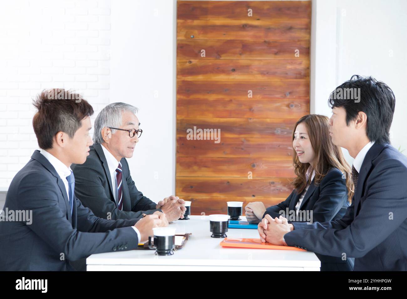 Four office workers during conference Stock Photo - Alamy