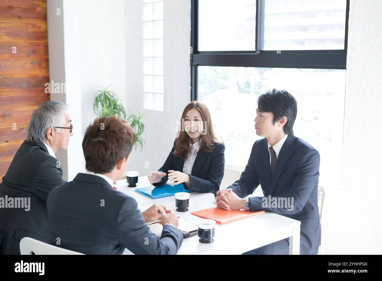 Four office workers during conference Stock Photo - Alamy