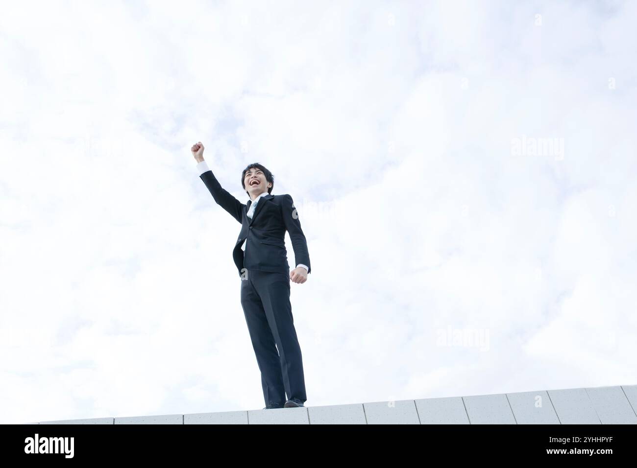 Low-angle businessman posing with guts Stock Photo - Alamy