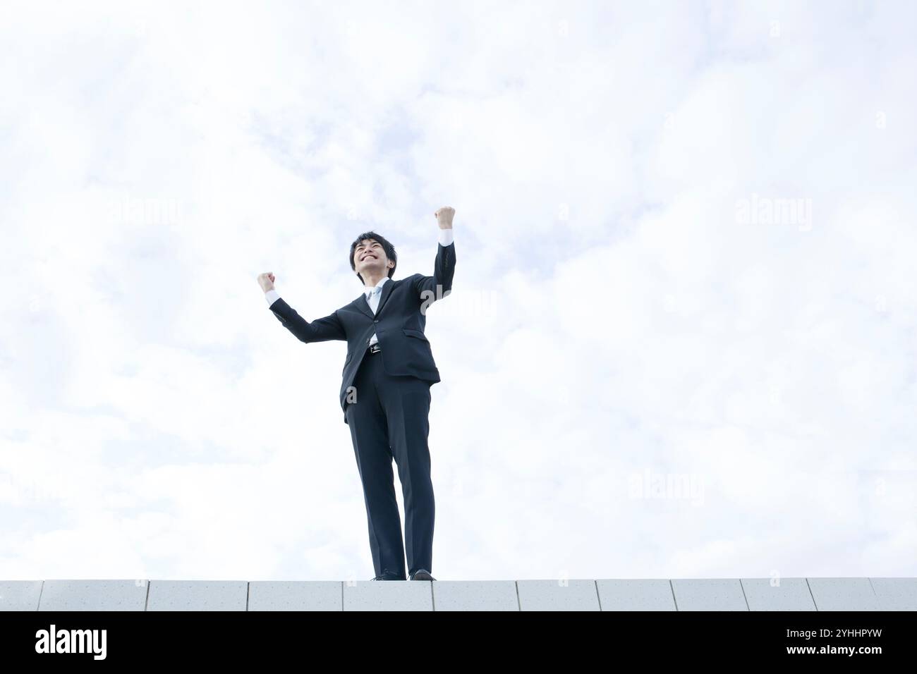 Low-angle businessman posing with guts Stock Photo - Alamy