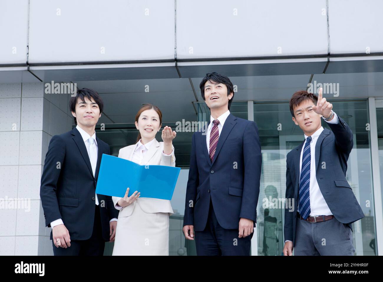 Two people pointing and two businessmen Stock Photo - Alamy