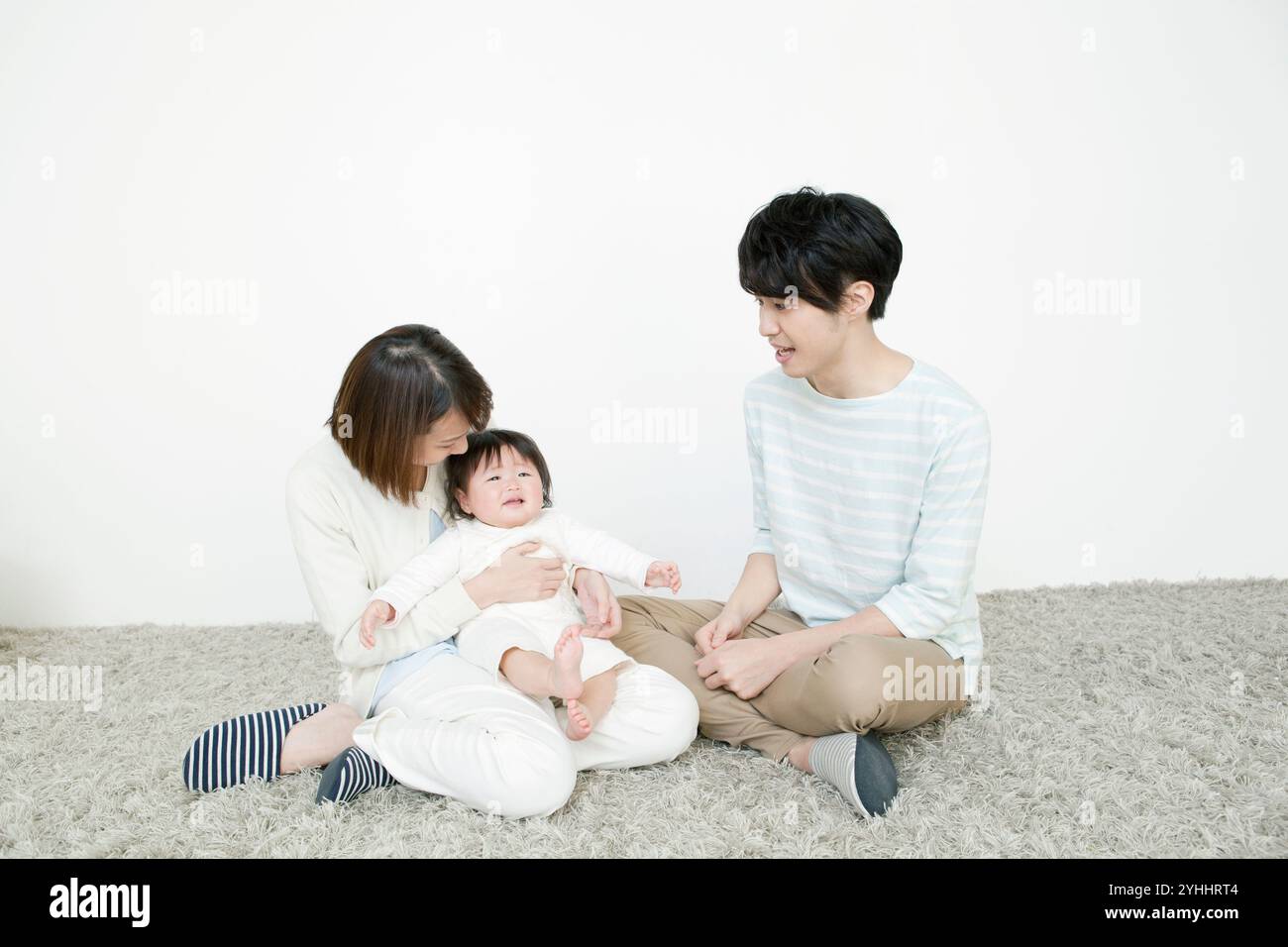 Three parents and children relaxing in the living room Stock Photo - Alamy