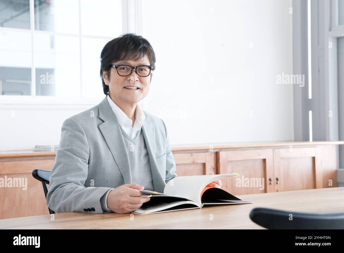 Man in his 60s reading a book Stock Photo - Alamy