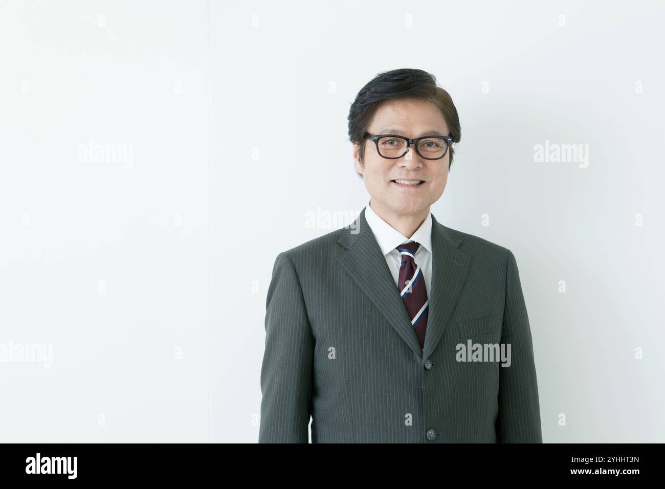 Smiling man in suit in his 60s Stock Photo - Alamy