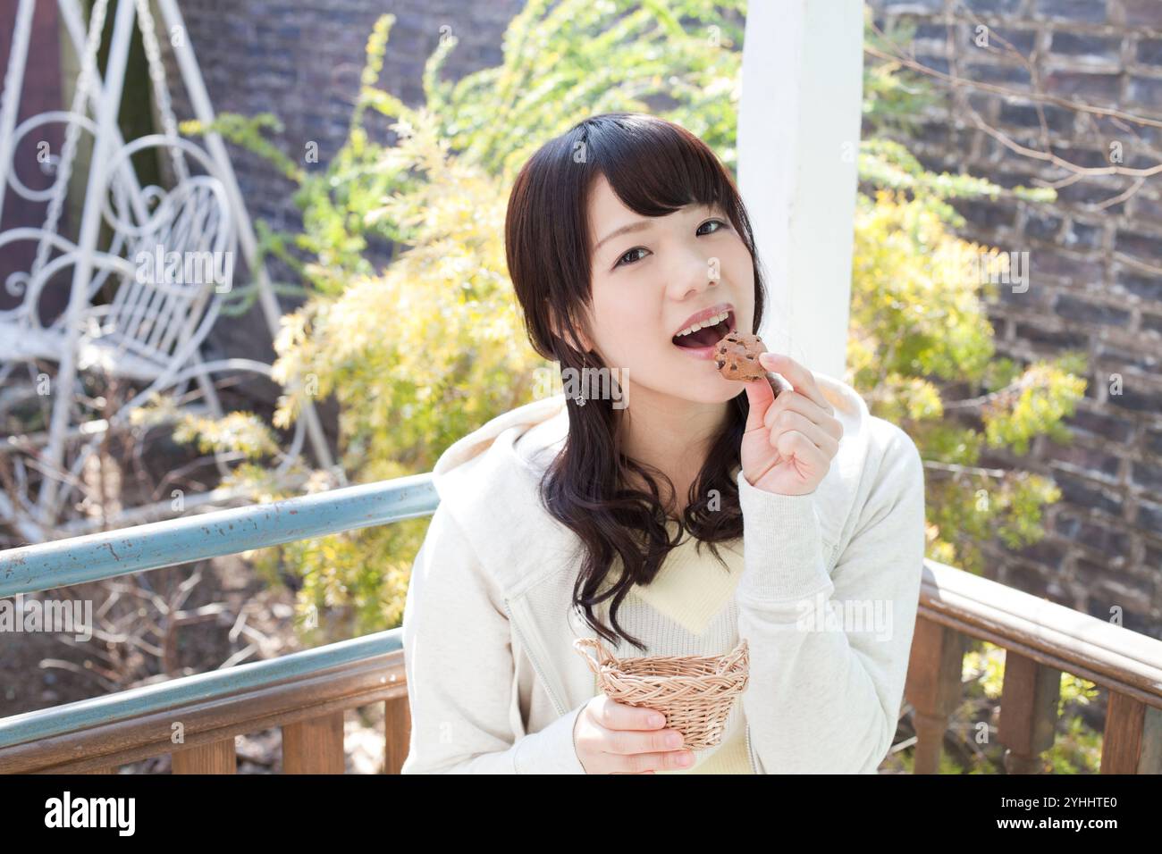 Beautiful woman eating cookies in hi-res stock photography and images ...