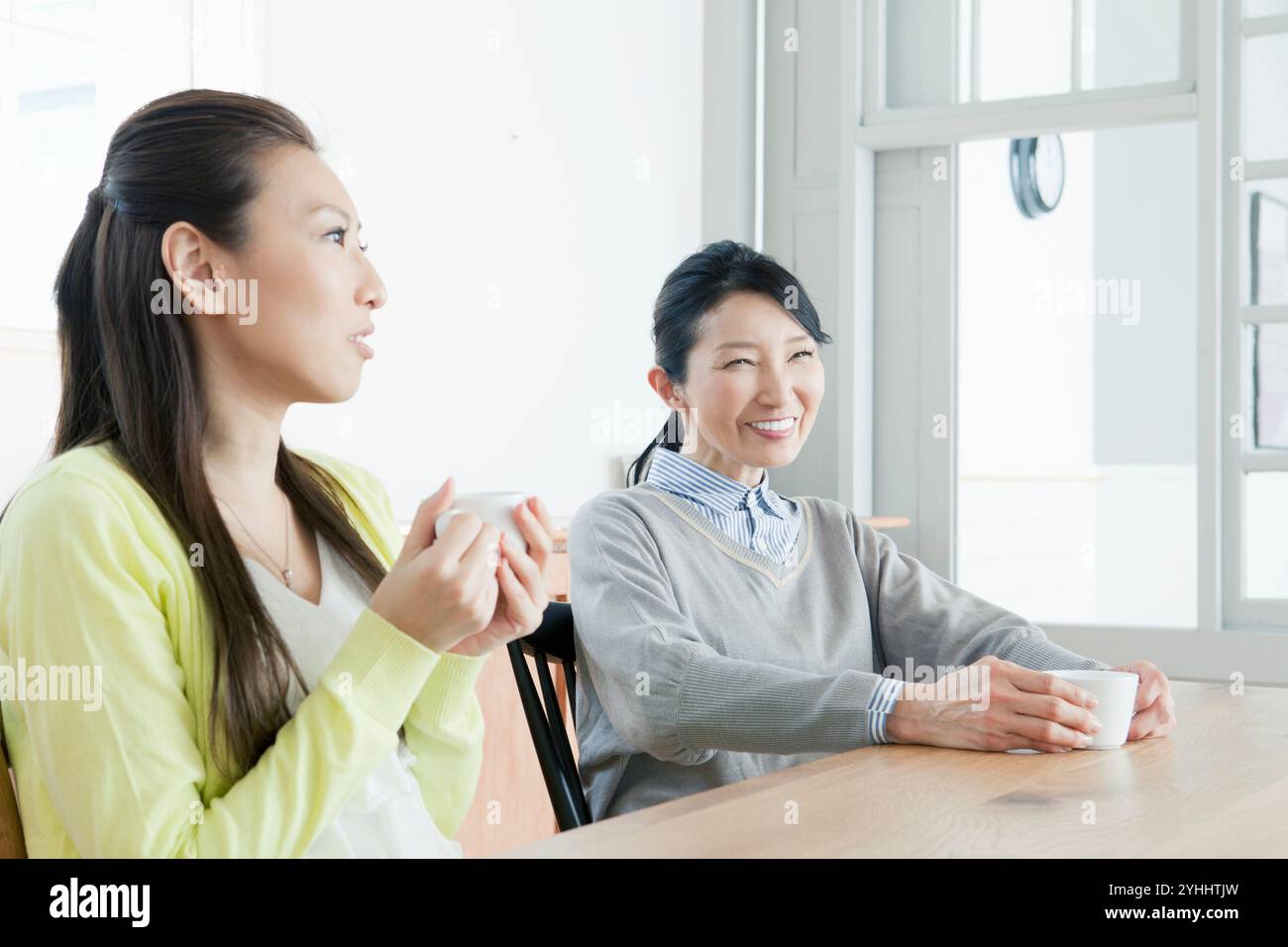 Parent and child enjoying tea Stock Photo - Alamy