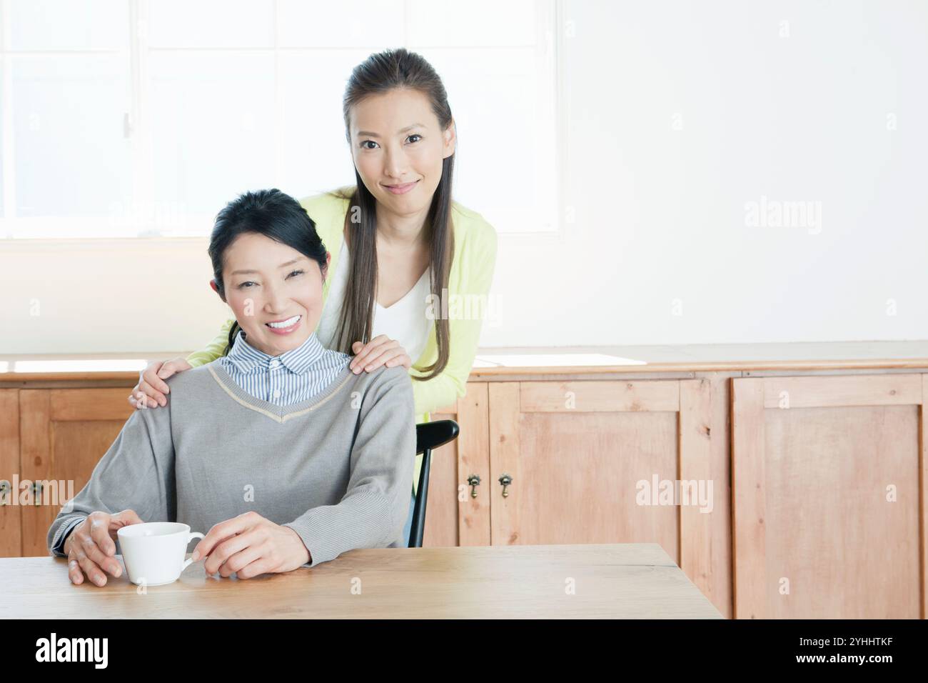 Parent and child enjoying tea Stock Photo - Alamy