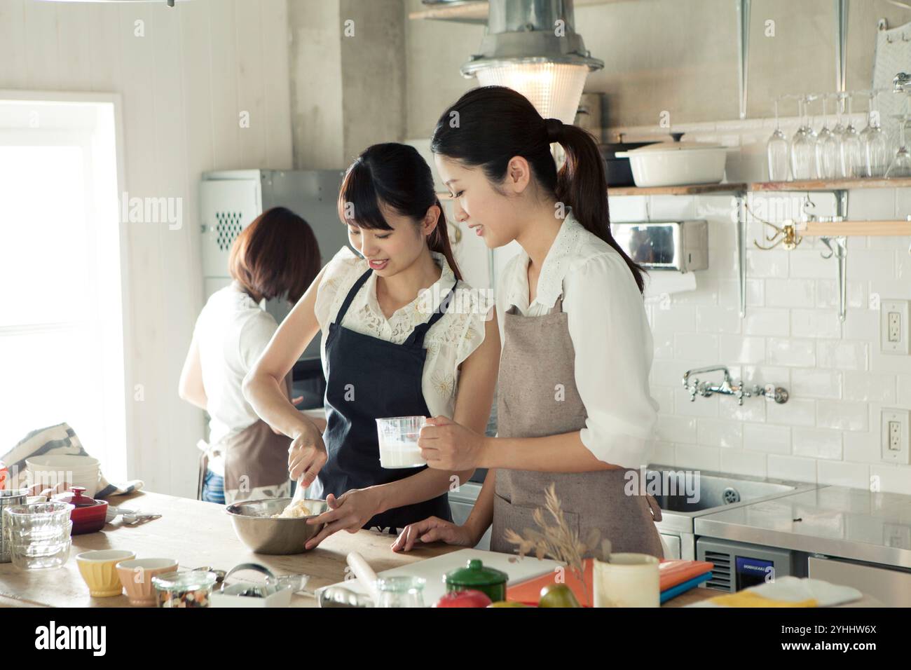 Three women in their 20s making sweets Stock Photo - Alamy