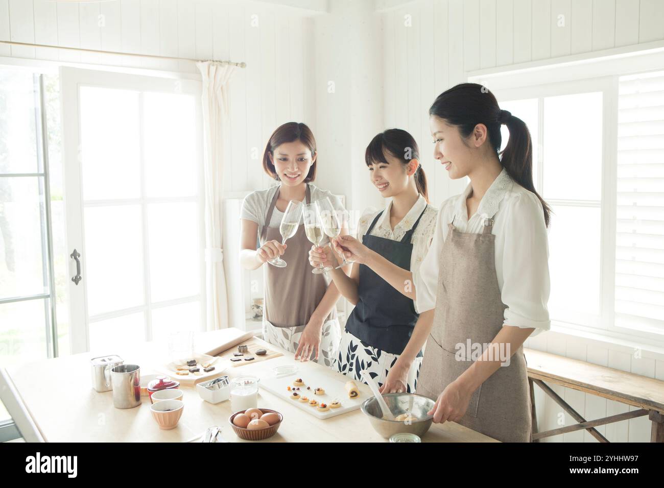 Three women in their 20s making a toast Stock Photo - Alamy