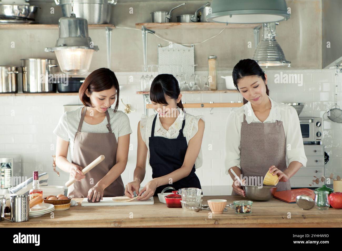 Three women in their 20s making sweets Stock Photo - Alamy