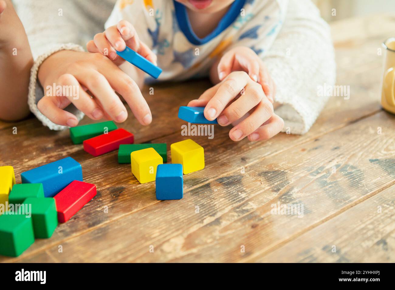 Hand playing with building blocks Stock Photo - Alamy