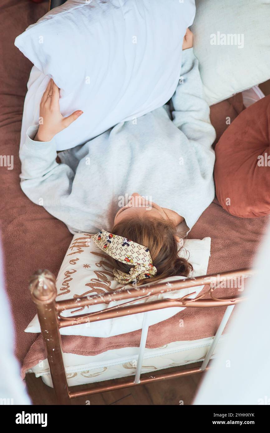 teenage girl in bed hugging pillows Stock Photo - Alamy