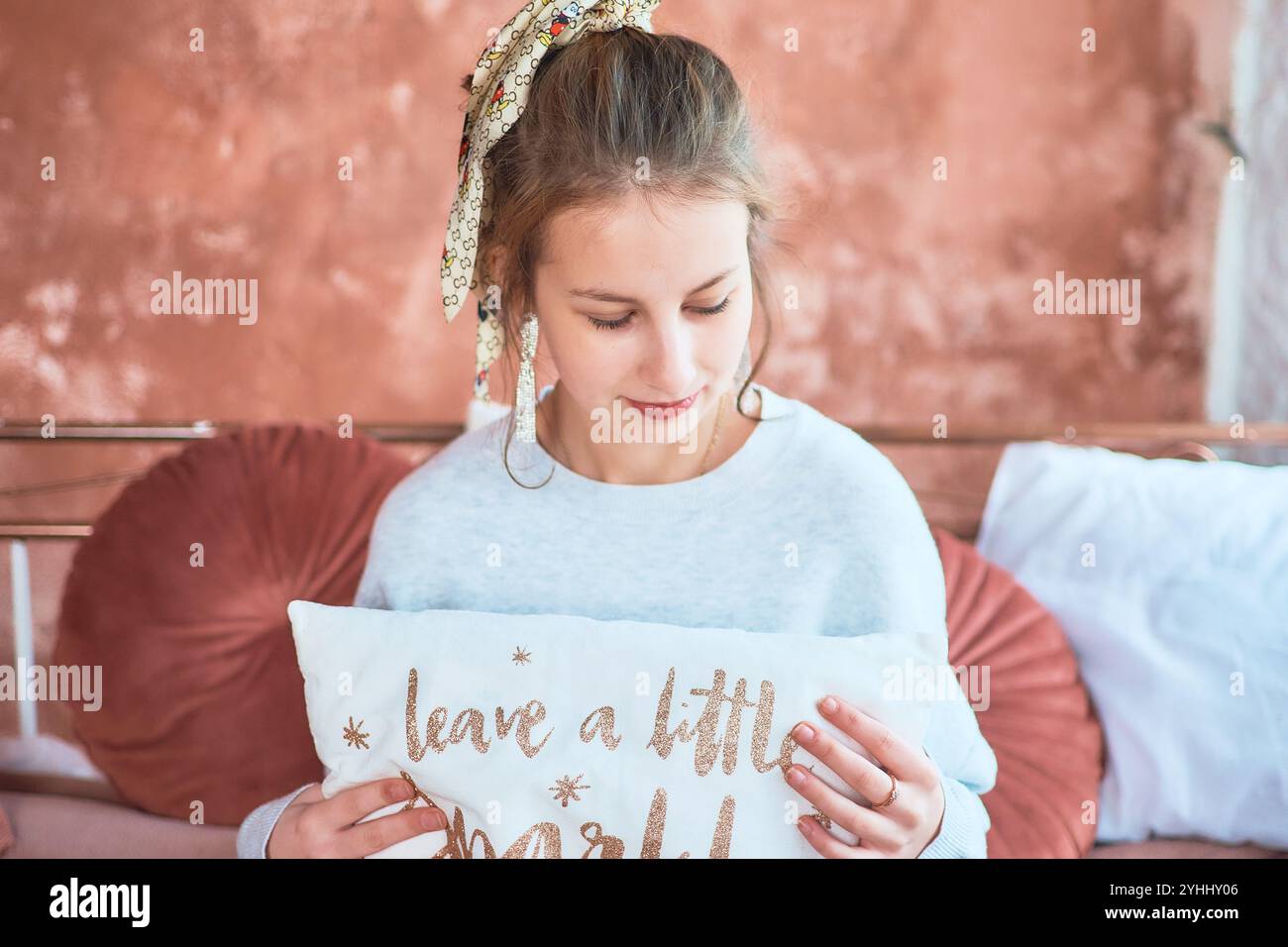 teenage girl in bed hugging pillows Stock Photo - Alamy