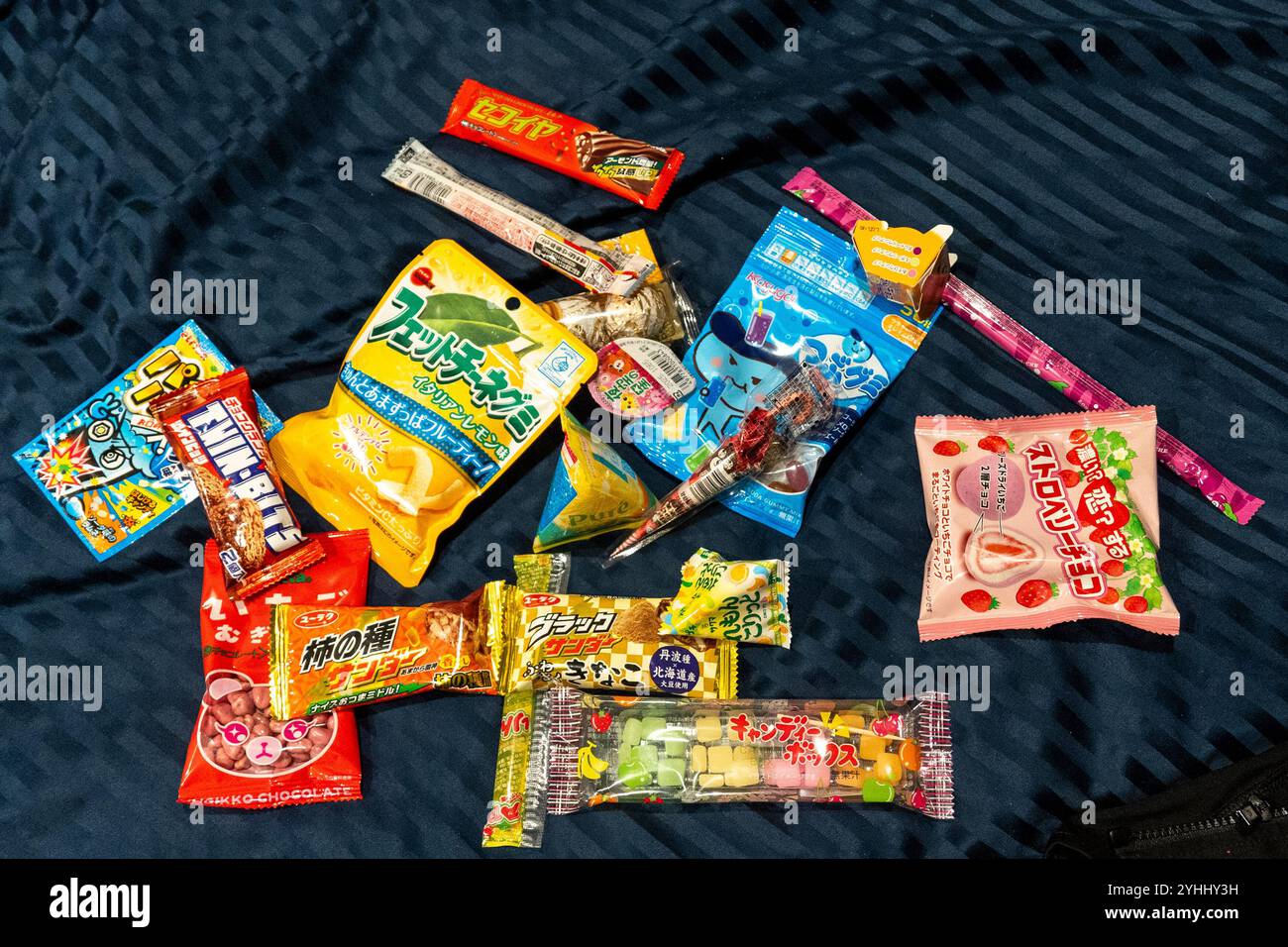 Colorful assortment of Japanese candies displayed on a soft fabric ...