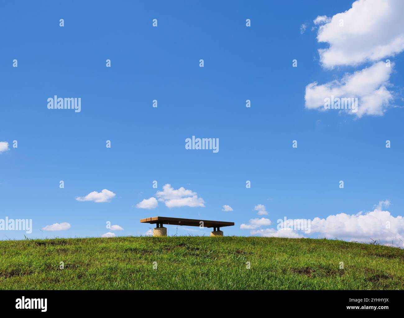 Tiny clouds and park hill bench Stock Photo - Alamy