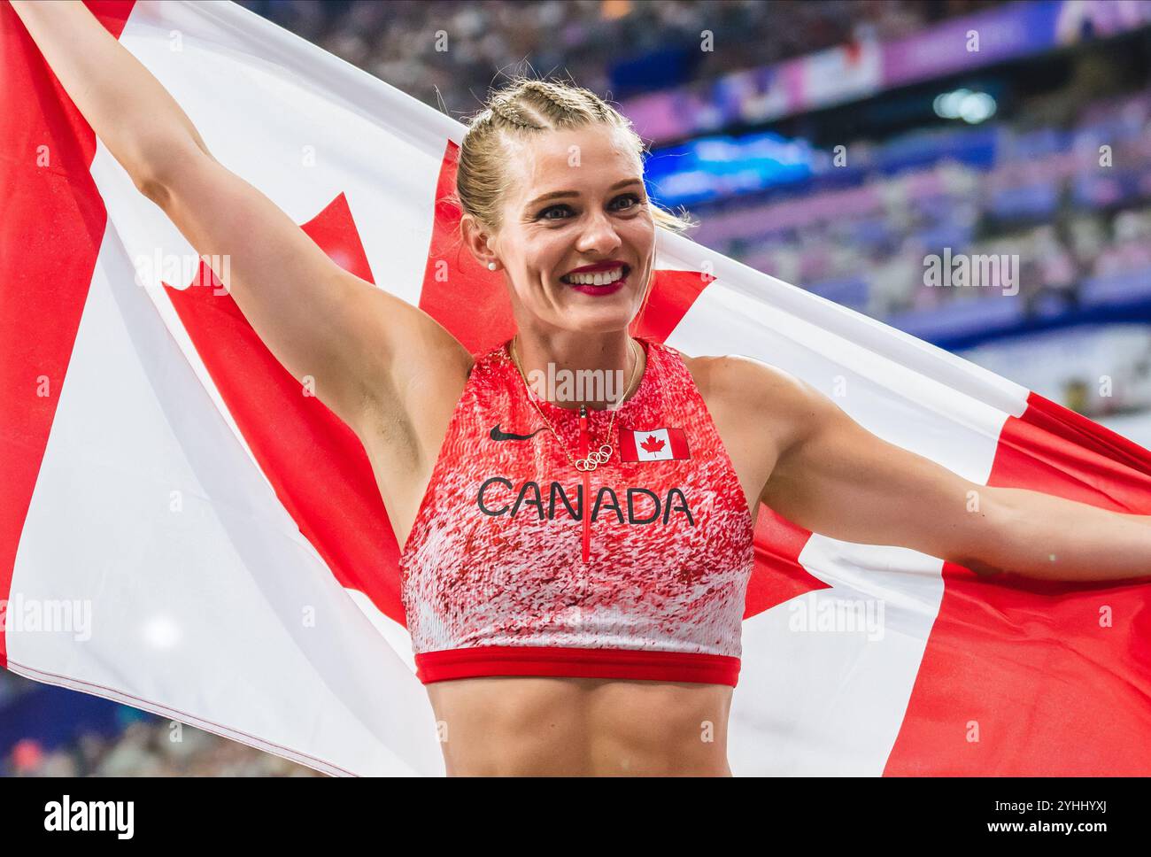 Alysha Newman celebrating her medal with her country's flag at the ...