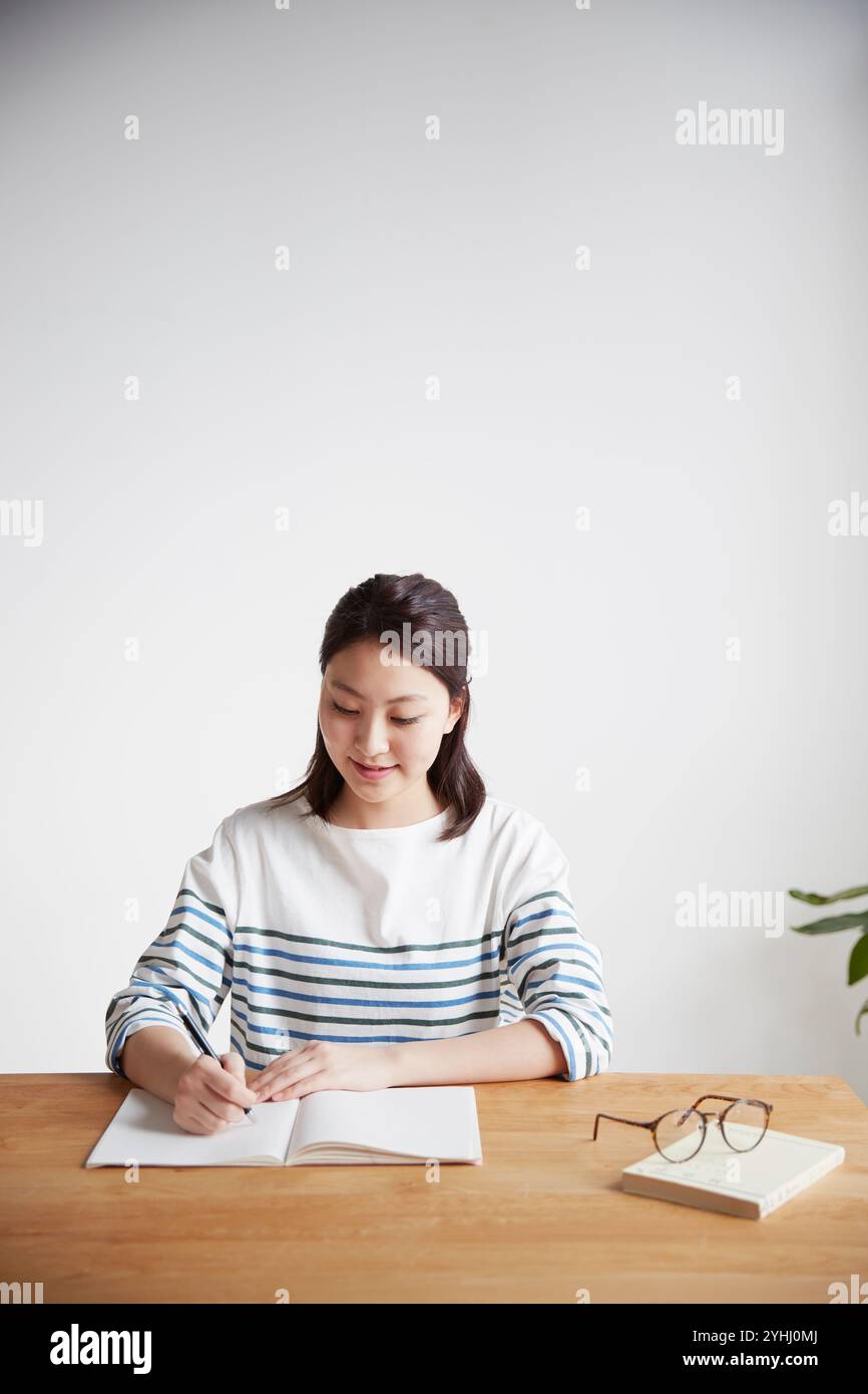 Young woman writing hi-res stock photography and images - Alamy