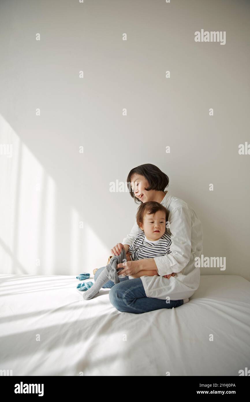 Boy and mother getting dressed Stock Photo - Alamy