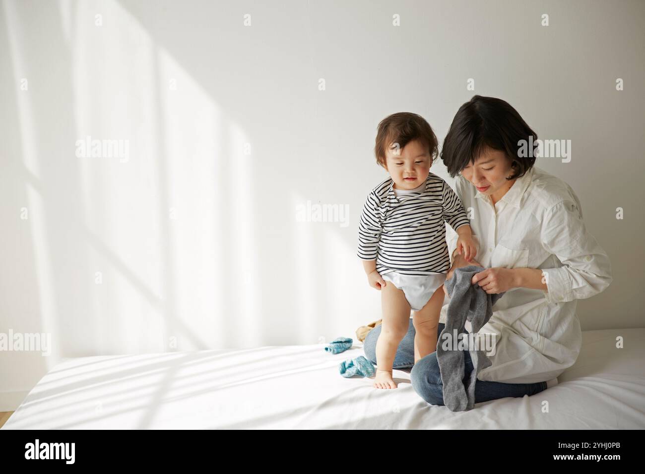 Boy and mother getting dressed Stock Photo - Alamy
